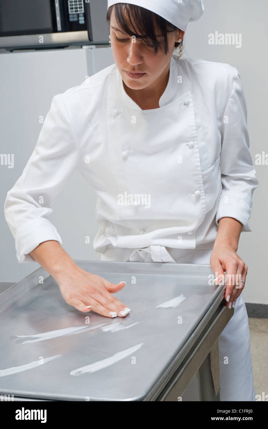 Baker working in bakery kitchen Stock Photo - Alamy