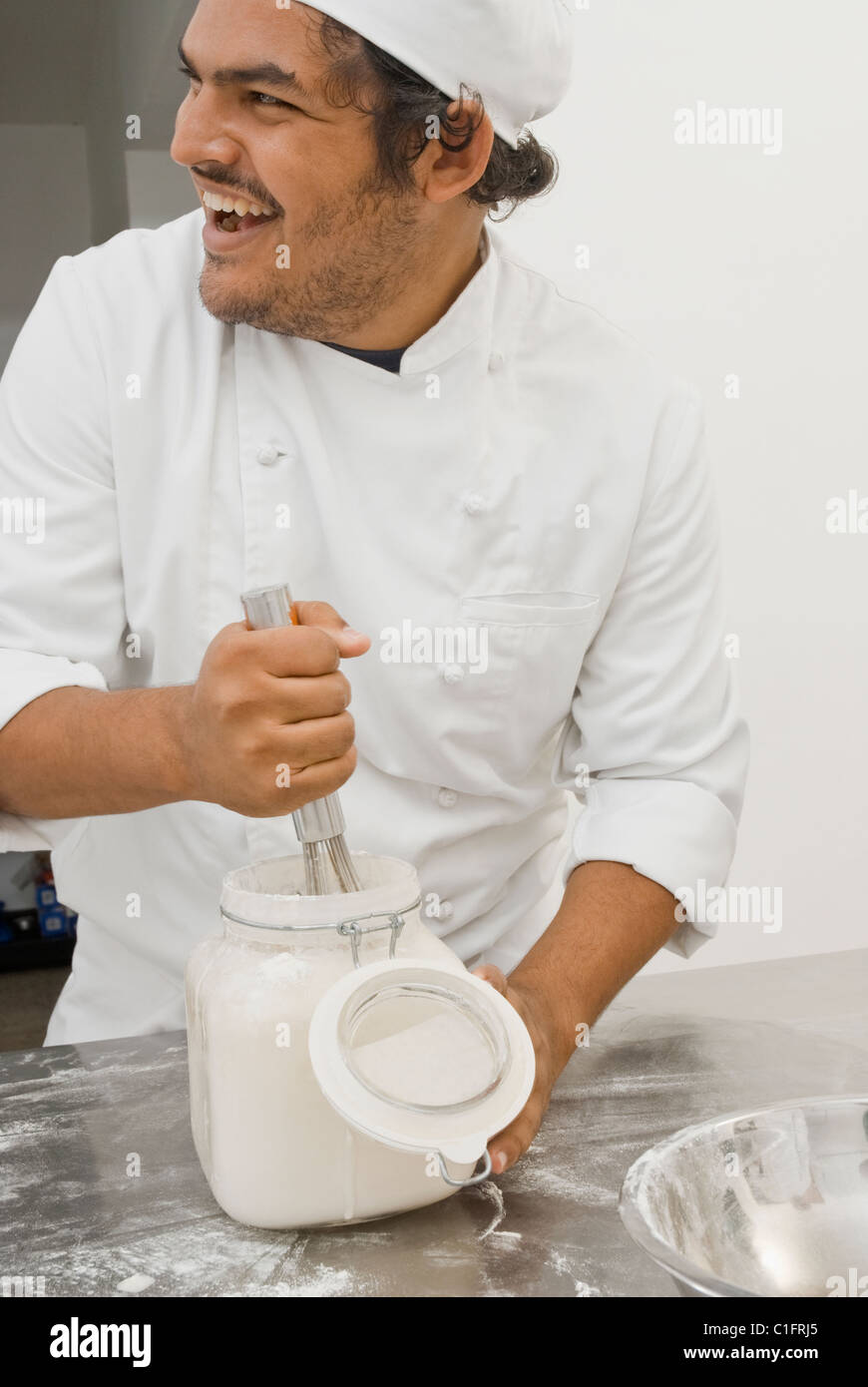 Baker working in bakery kitchen Stock Photo - Alamy