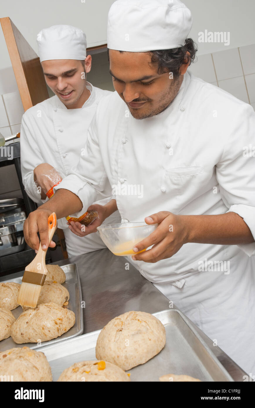 Bakers preparing bread in bakery kitchen Stock Photo - Alamy