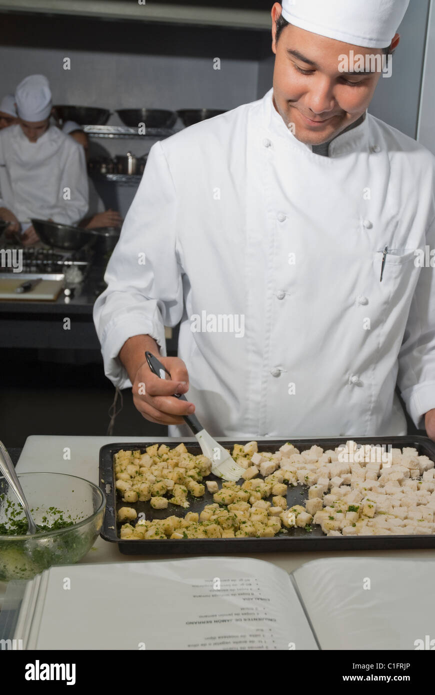 Baker working in bakery kitchen Stock Photo - Alamy
