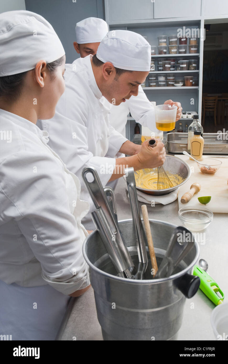 Baker stirring batter in bakery kitchen Stock Photo - Alamy