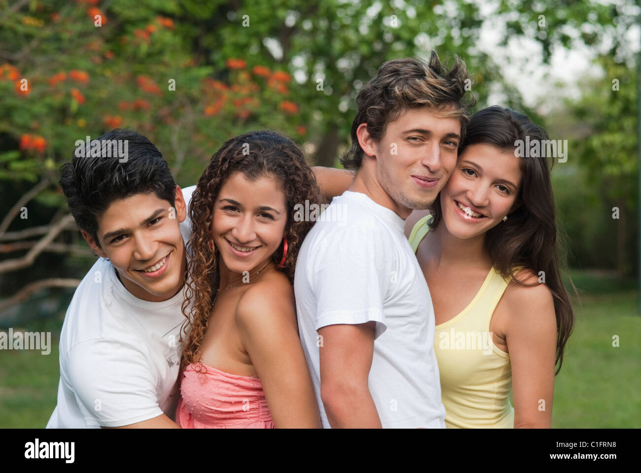 Hispanic couples hugging outdoors together Stock Photo - Alamy