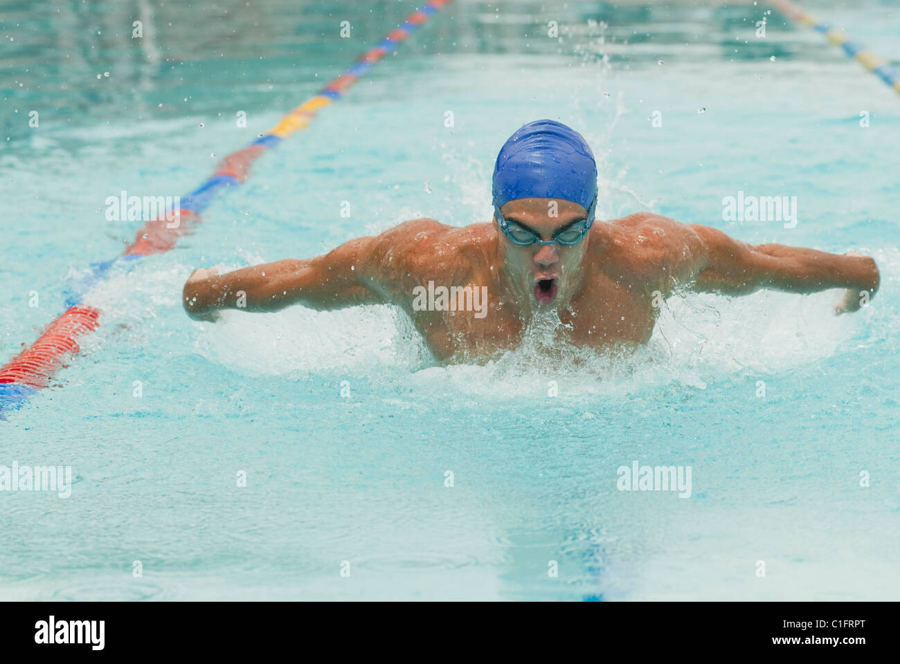 Hispanic man swimming in swimming pool Stock Photo - Alamy