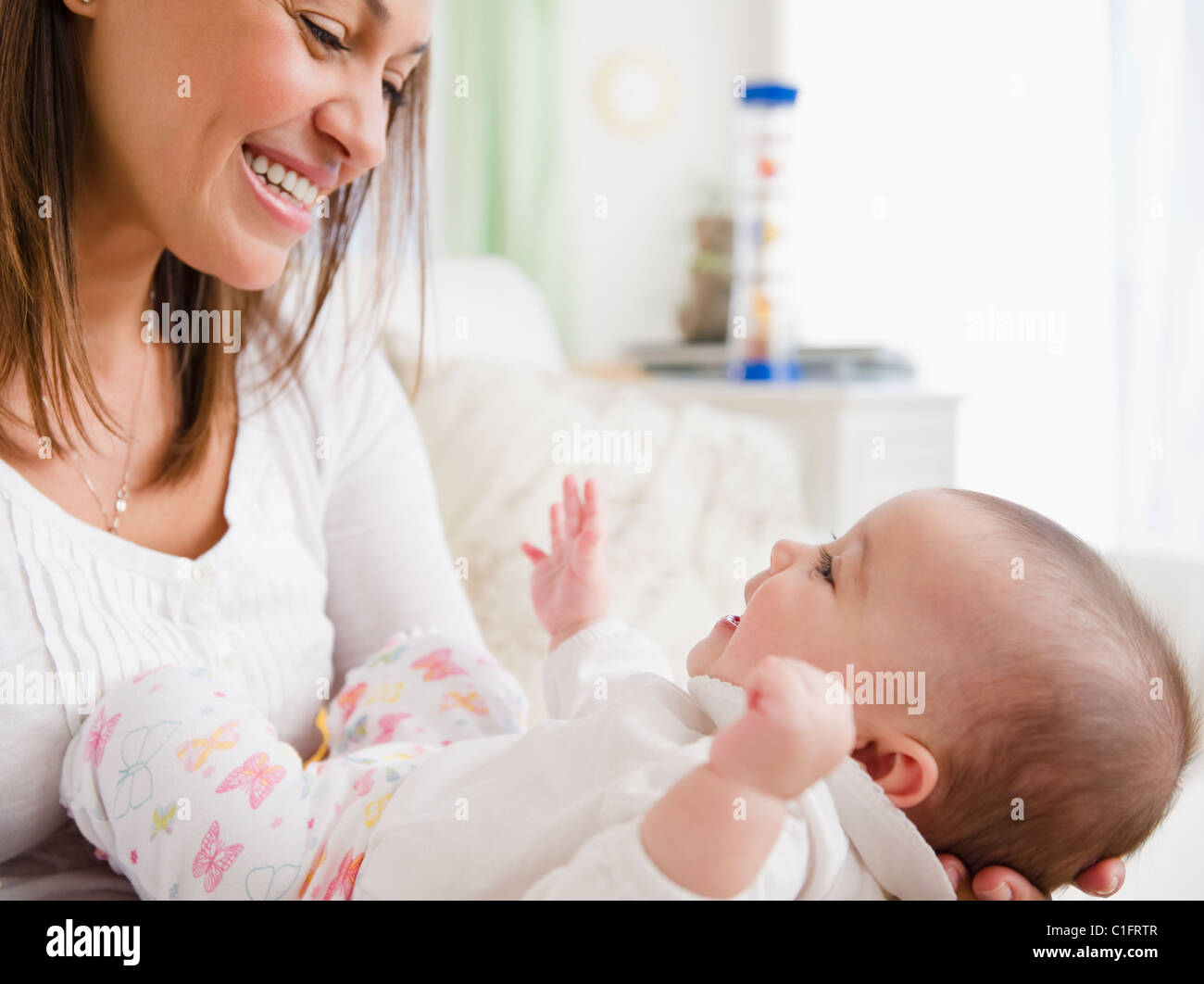 Mother smiling at baby Stock Photo - Alamy