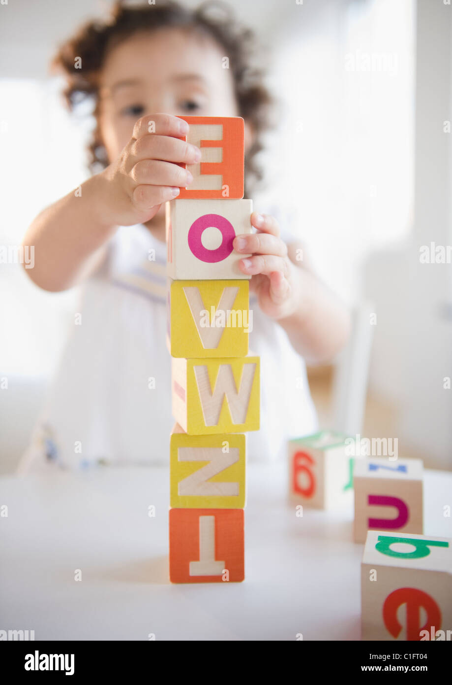 Mixed race girl stacking blocks Stock Photo - Alamy