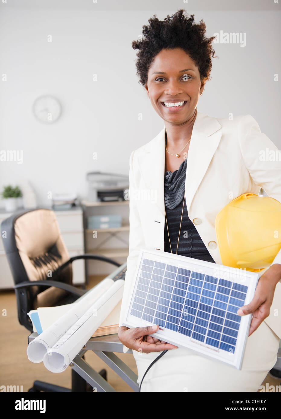 Black businesswoman holding solar panel Stock Photo - Alamy