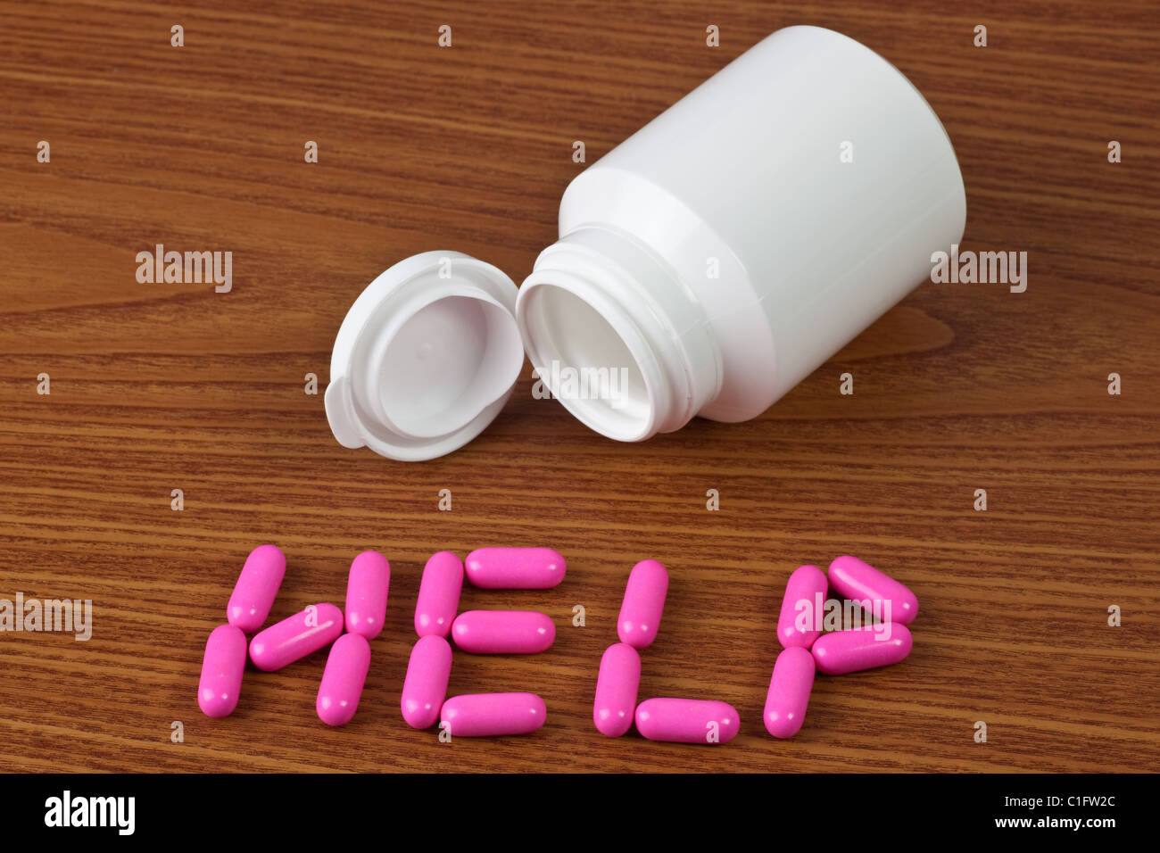 Medicine capsules forming the word HELP on a table Stock Photo - Alamy