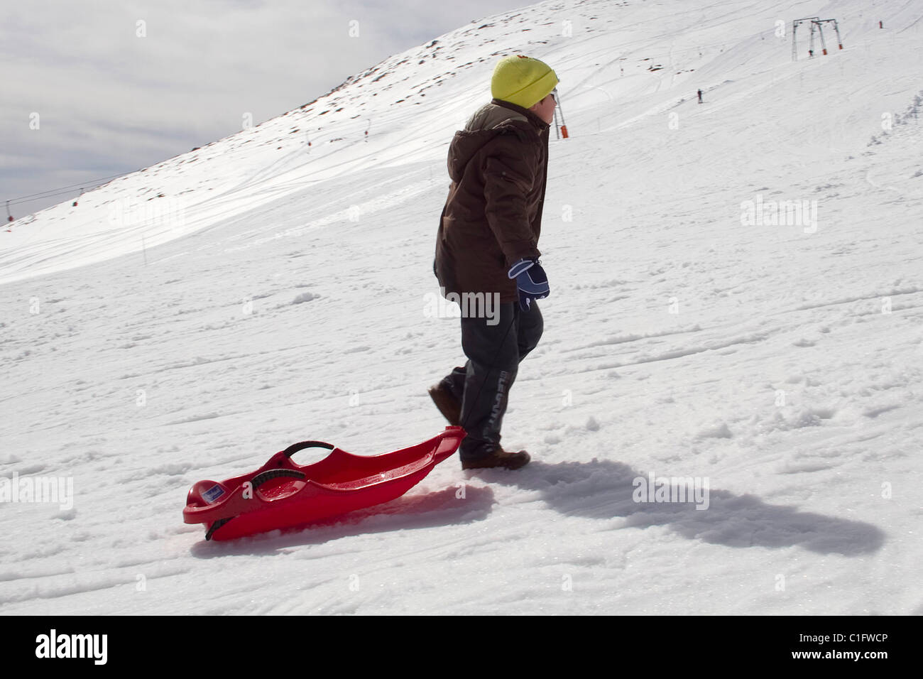 A children is pulling his sledge Stock Photo - Alamy