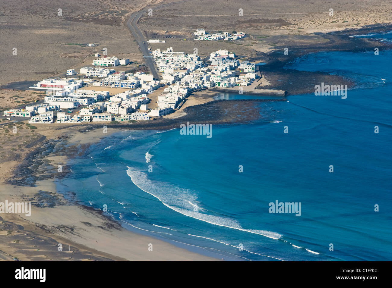 View from the Risco de Famara Range of the town and fine surf beach at ...