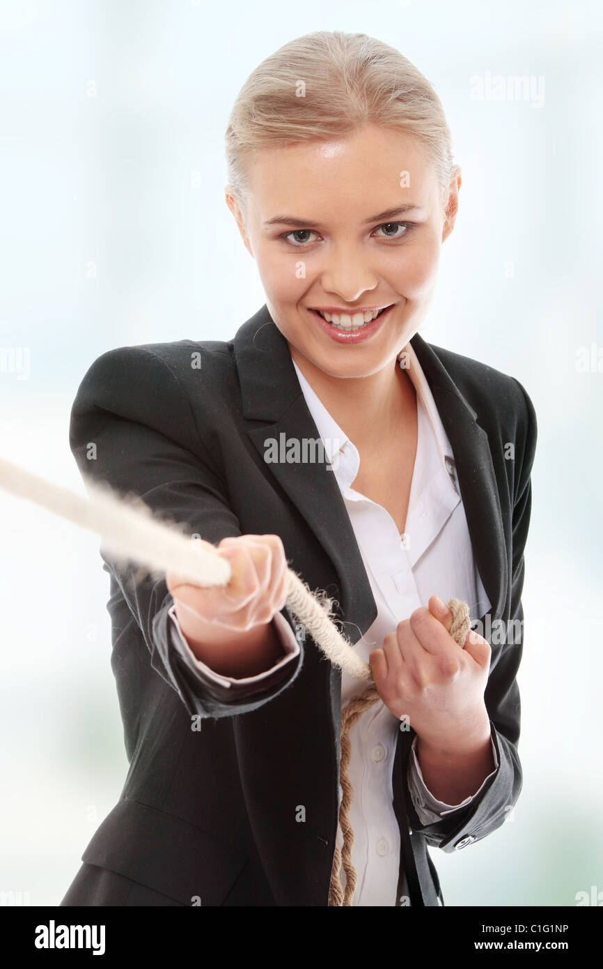 Businesswoman pulling on a piece of rope Stock Photo - Alamy