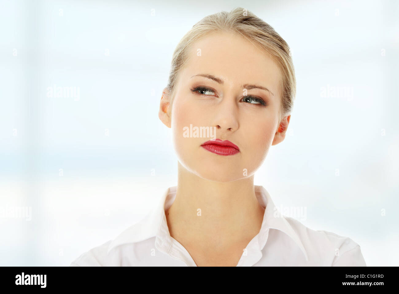 Thoughtful businesswoman looking left Stock Photo - Alamy
