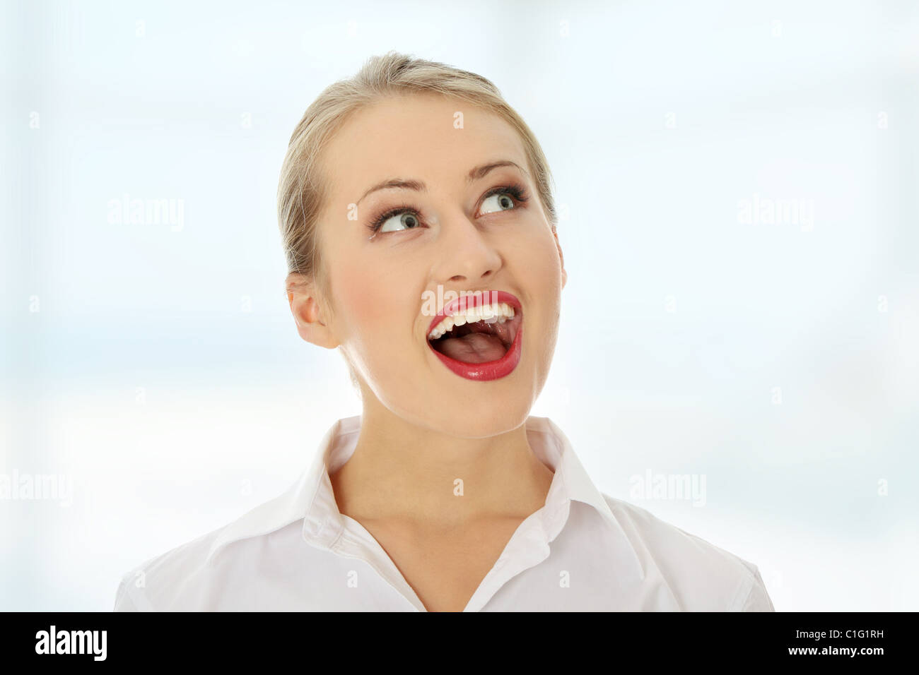 Amazed happy businesswoman looking right Stock Photo - Alamy