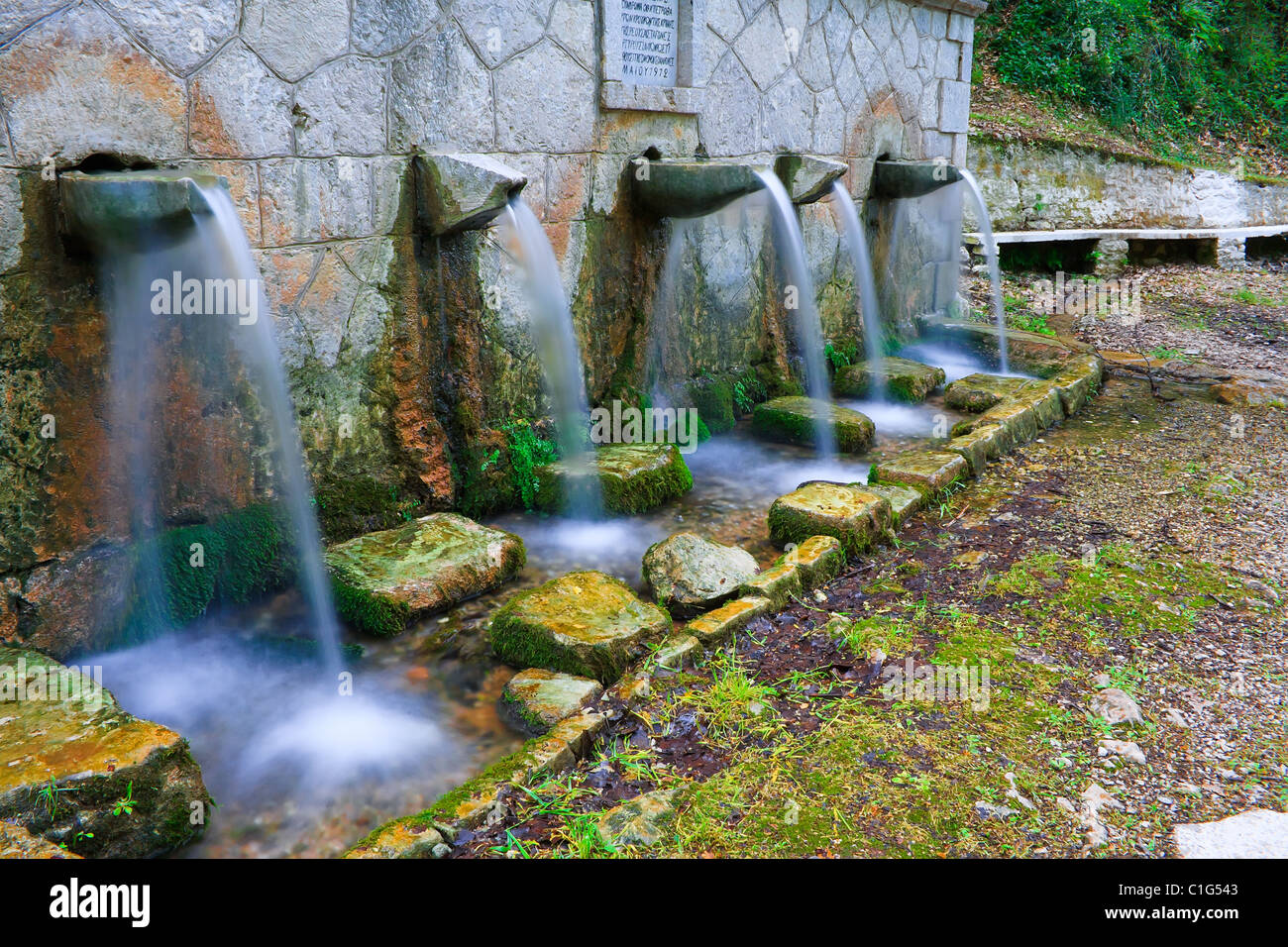 Water spring in Ancient park in Greece Stock Photo - Alamy