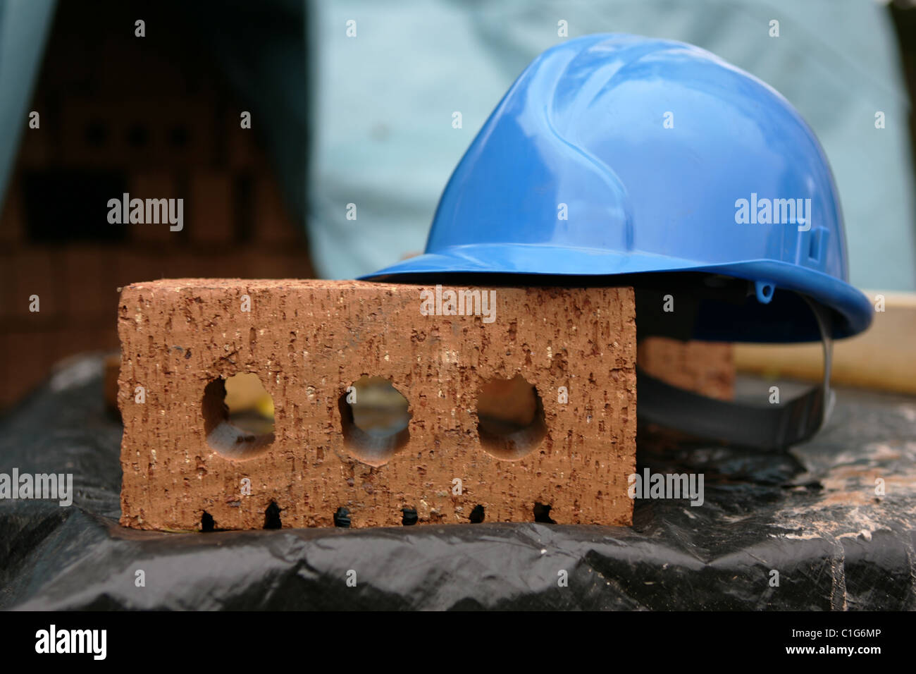 Construction brick and hard safety hat Stock Photo - Alamy