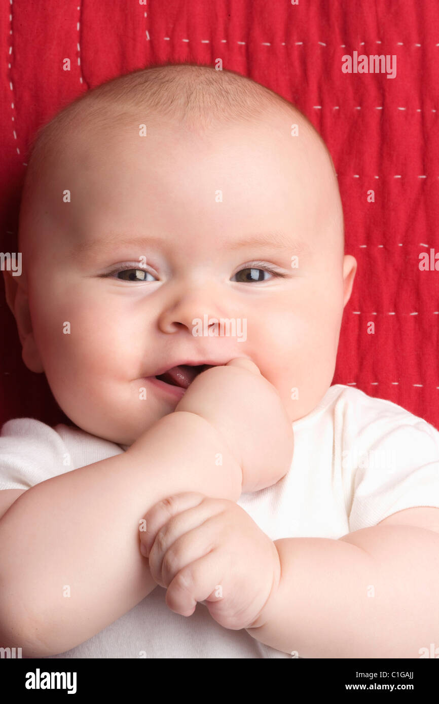 Caucasian baby biting hand Stock Photo - Alamy