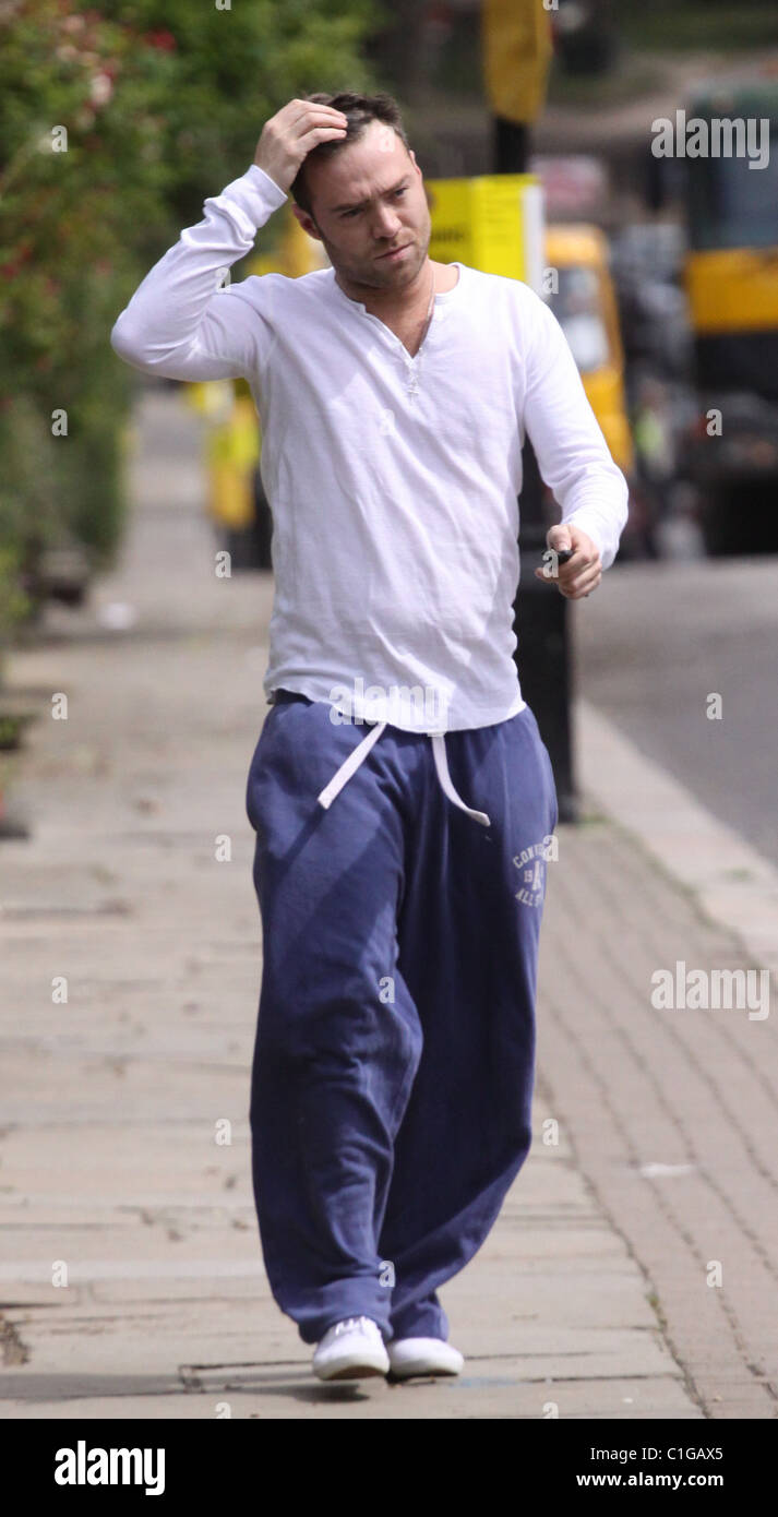 DJ Tom Crane emerges from his house to remove a parking ticket from his ...