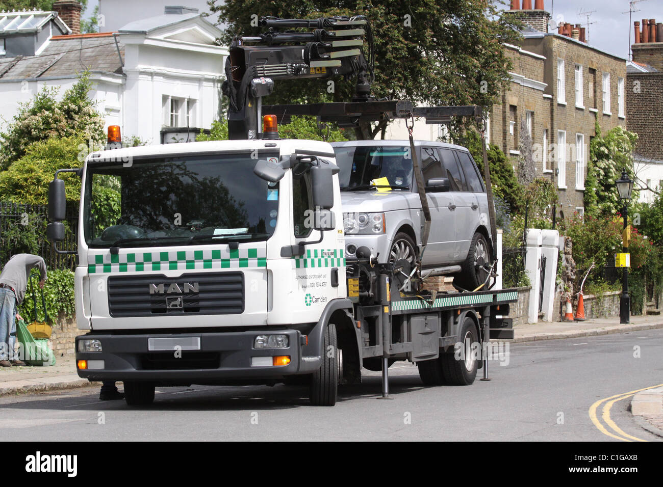 DJ Tom Crane emerges from his house to remove a parking ticket from his ...