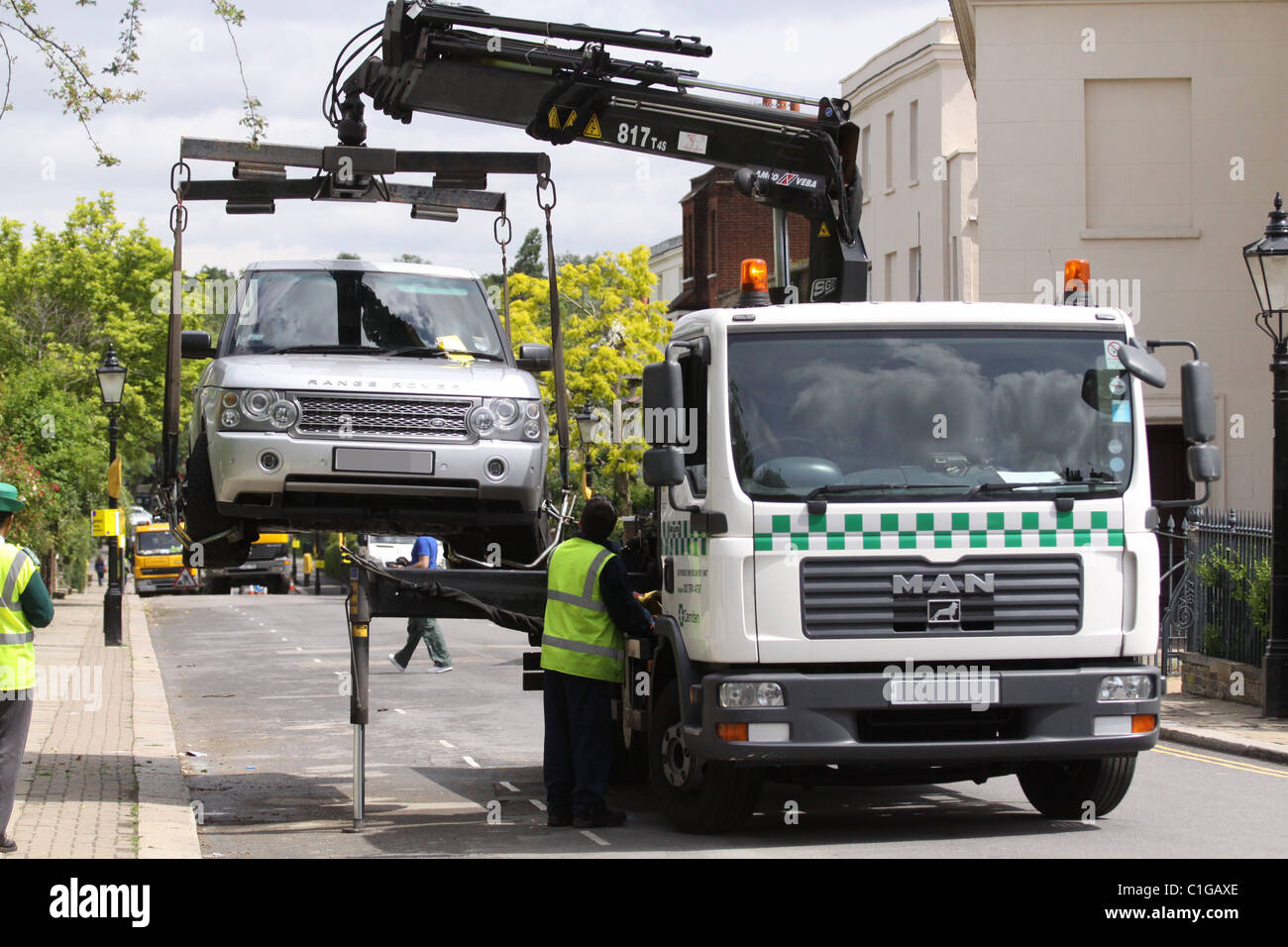 DJ Tom Crane emerges from his house to remove a parking ticket from his ...