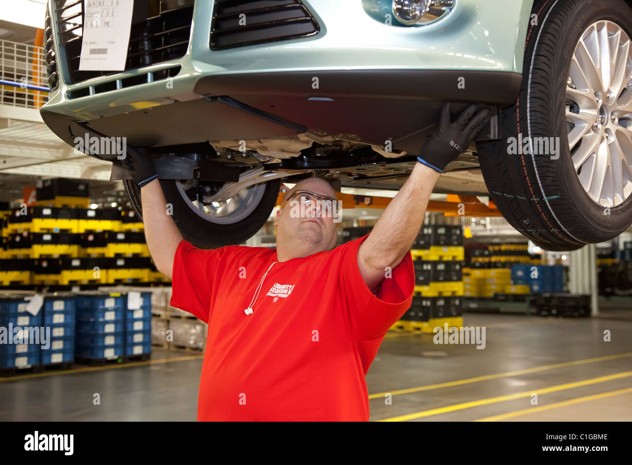 Workers assemble the 2012 Ford Focus at Ford Motor Co.'s Michigan ...