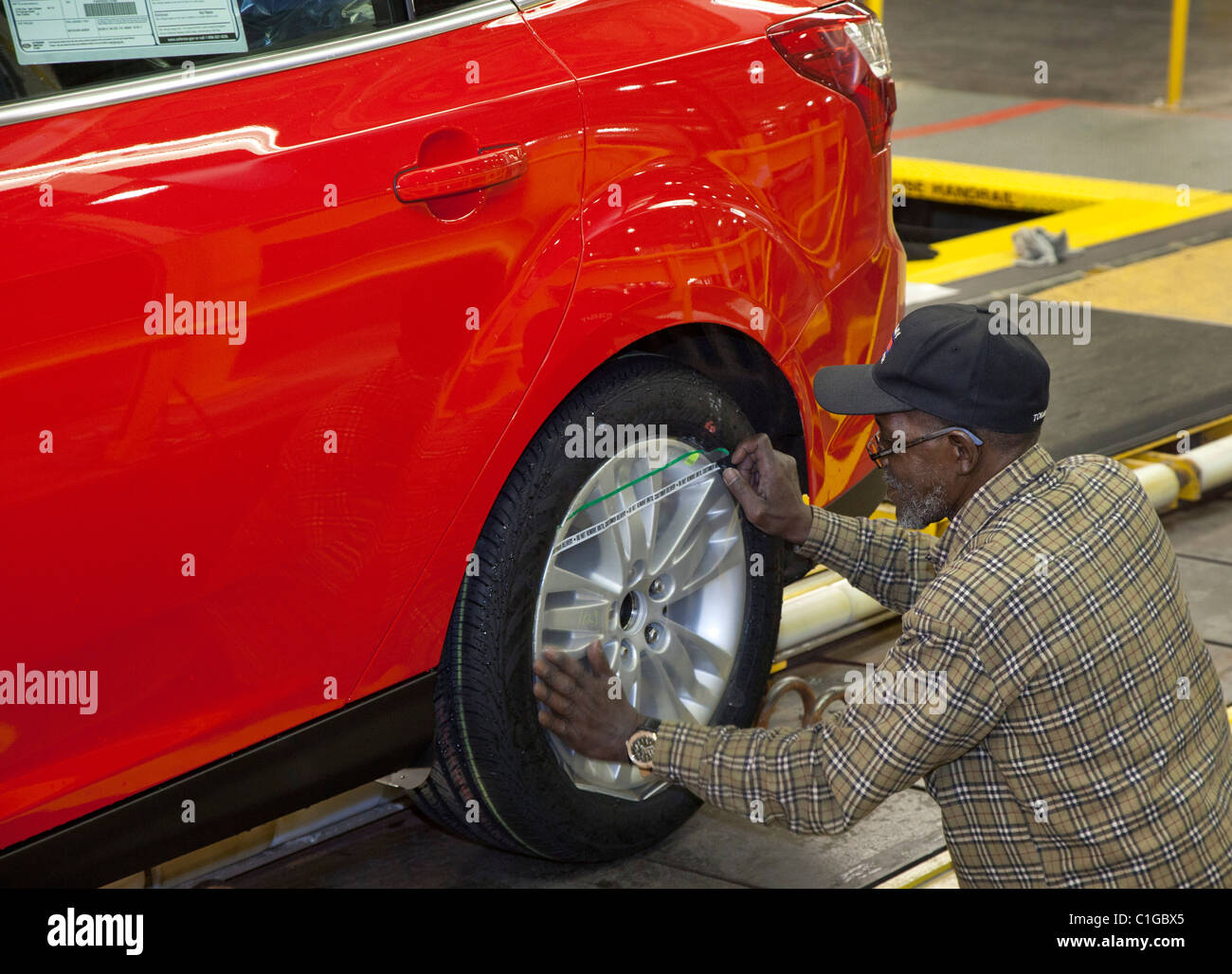 Workers assemble the 2012 Ford Focus at Ford Motor Co.'s Michigan ...