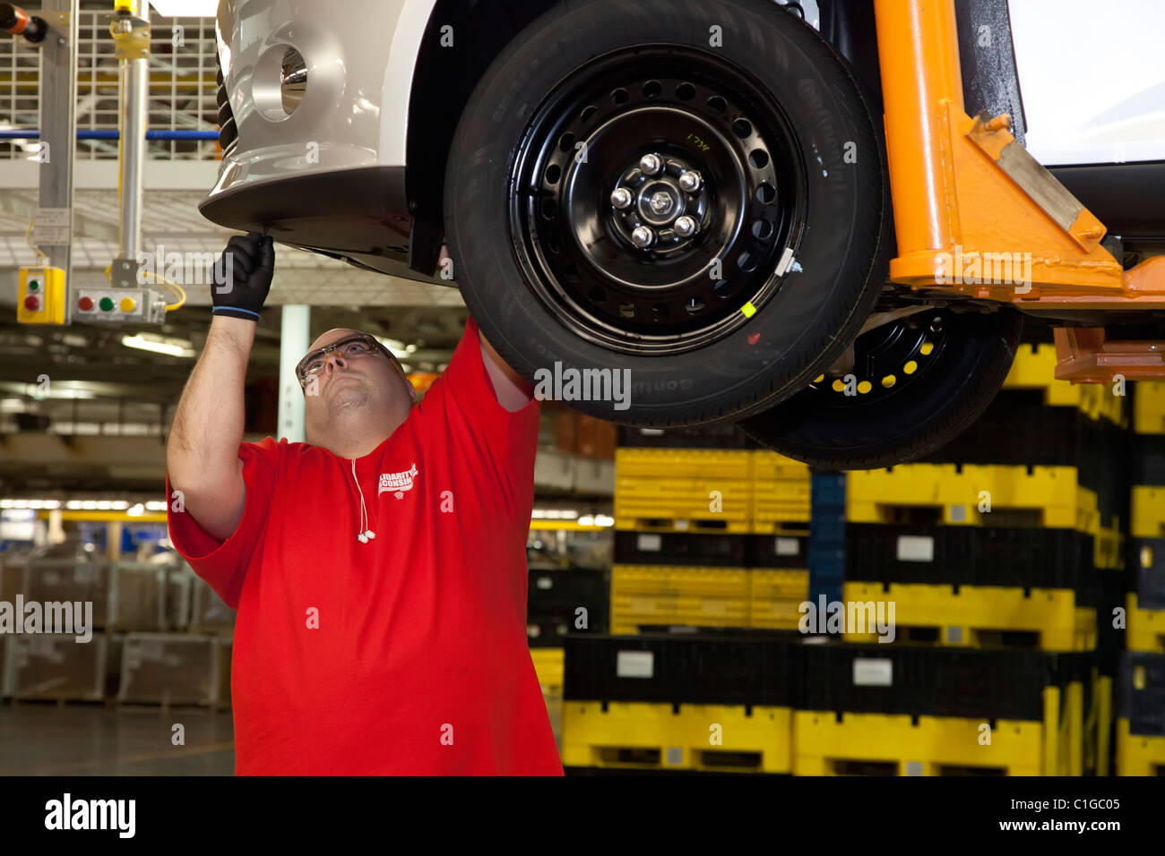 Workers assemble the 2012 Ford Focus at Ford Motor Co.'s Michigan ...