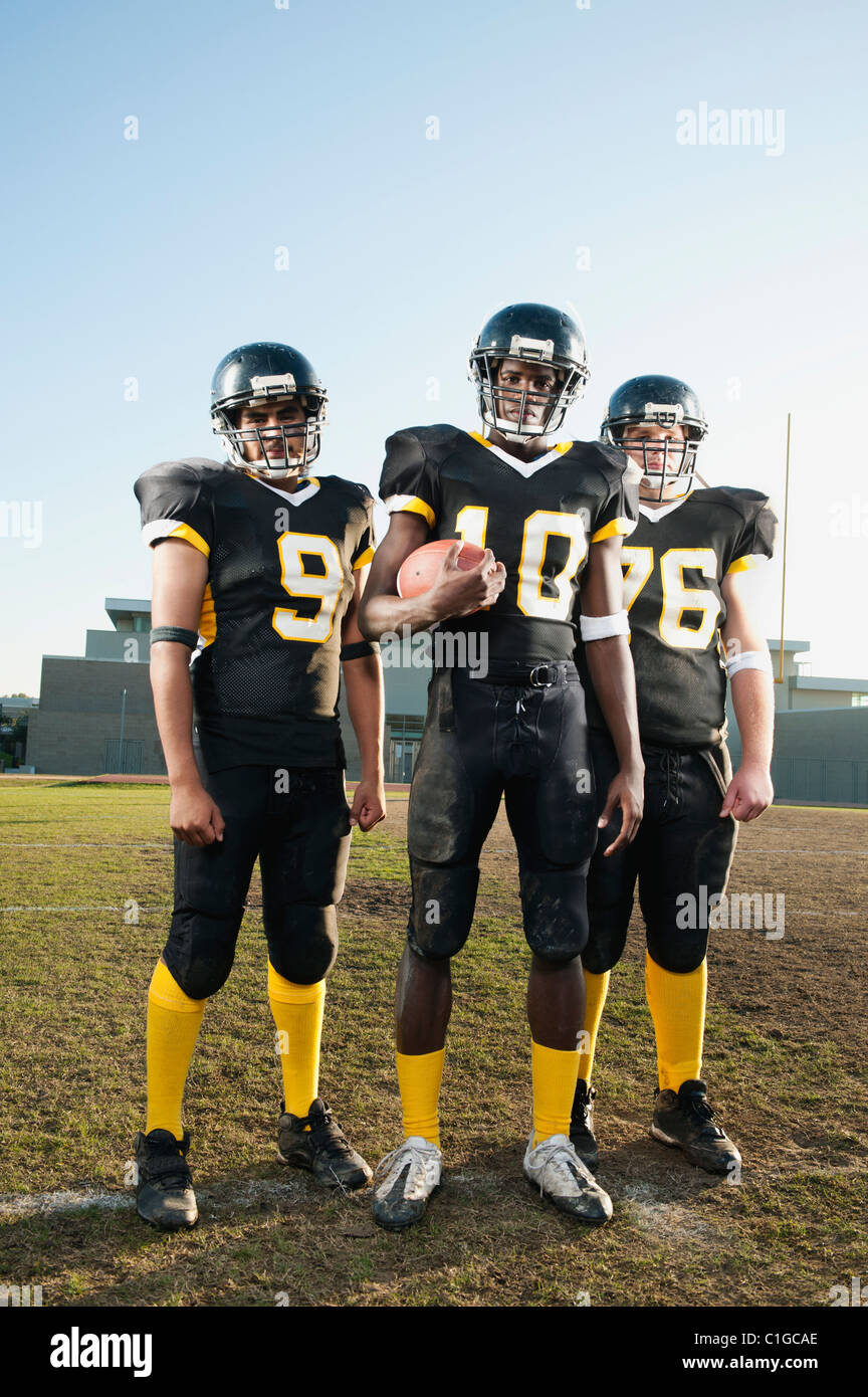 Football players standing on football field Stock Photo - Alamy