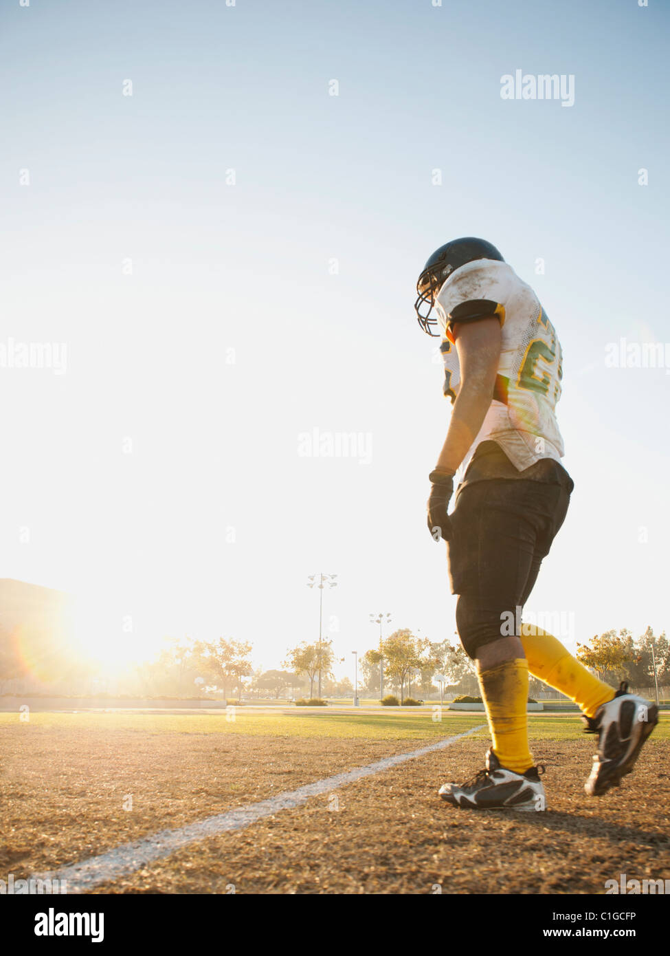 Hispanic football player walking on football field Stock Photo - Alamy