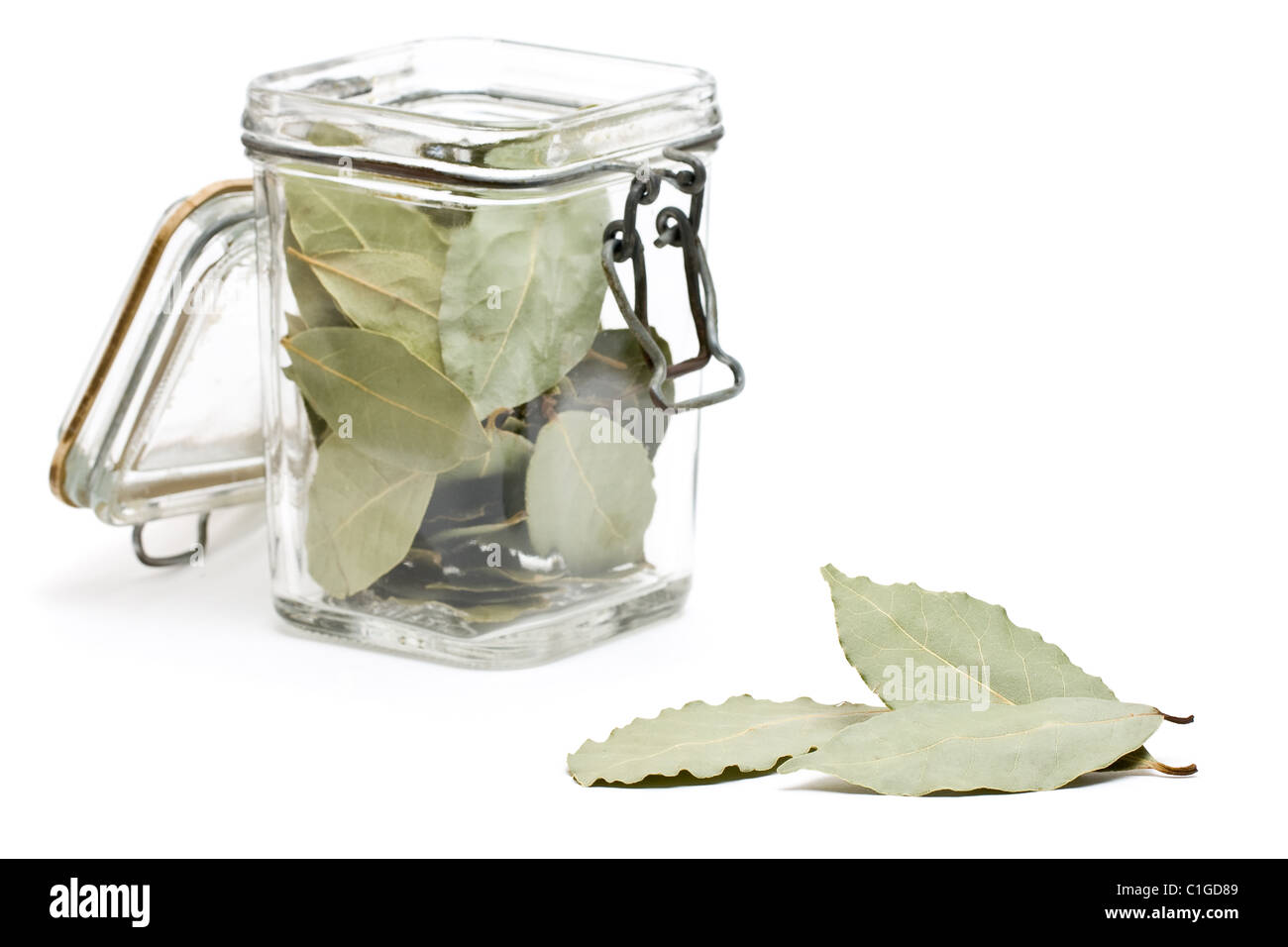 Dried bay leaves with jar over white background Stock Photo - Alamy