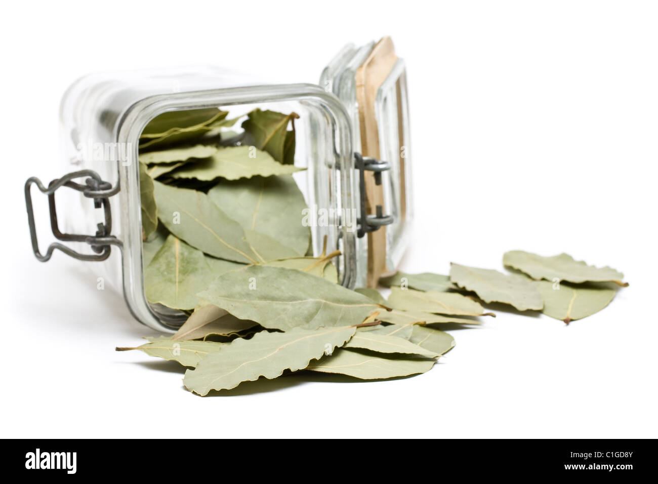 Dried bay leaves with jar over white background Stock Photo - Alamy