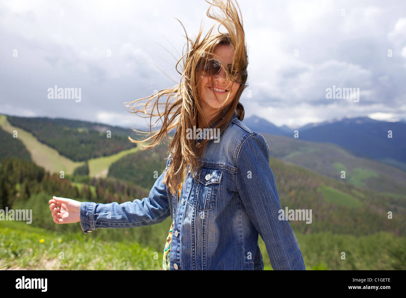 Smiling Caucasian woman walking outdoors Stock Photo - Alamy