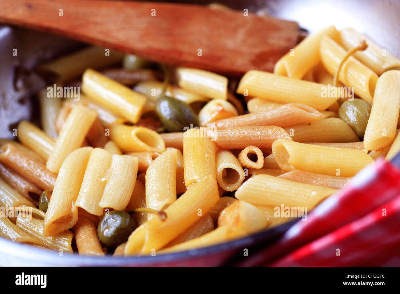 Pasta stir fried with garlic and capers Stock Photo - Alamy