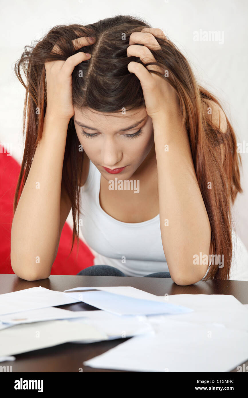 A young beautiful woman stressed because of bills Stock Photo - Alamy