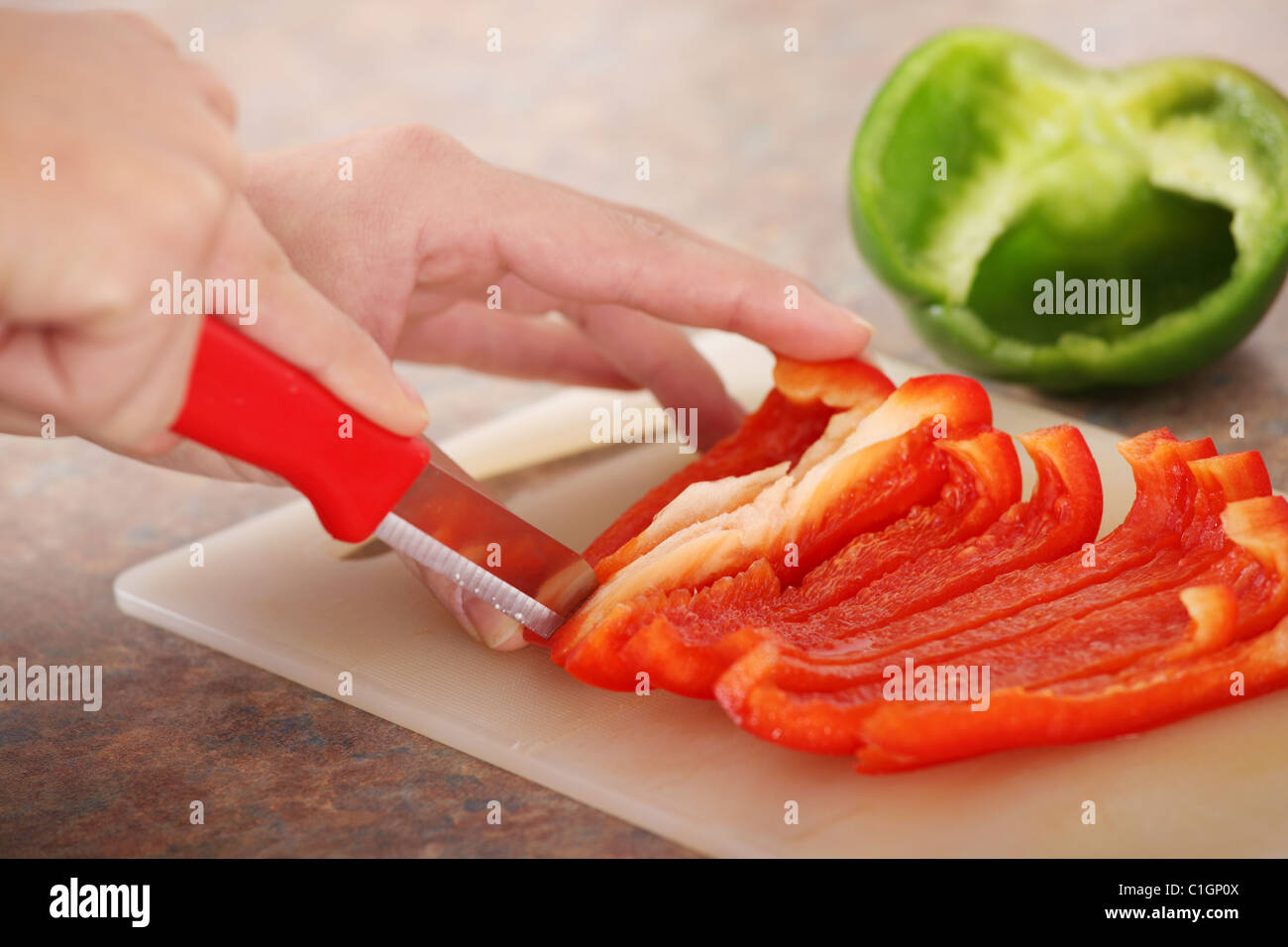 Chopping bright yellow pepper knife hi-res stock photography and images ...
