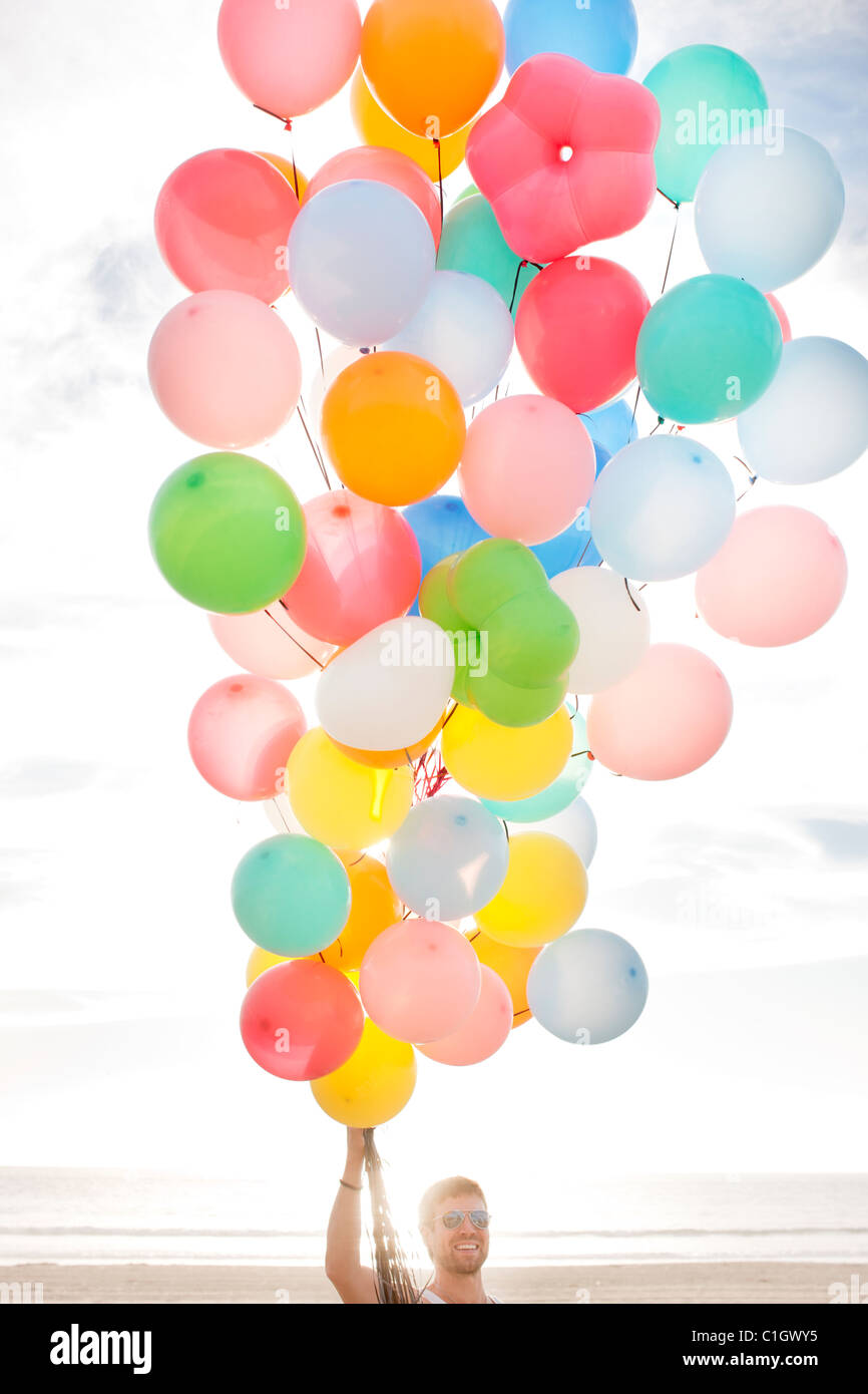 Mid adult man floating balloon hi-res stock photography and images - Alamy