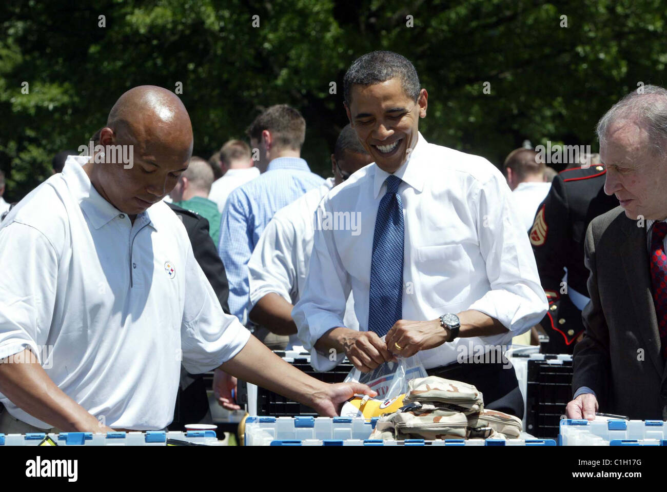 US President Barack Obama helps to assemble military care packages with ...