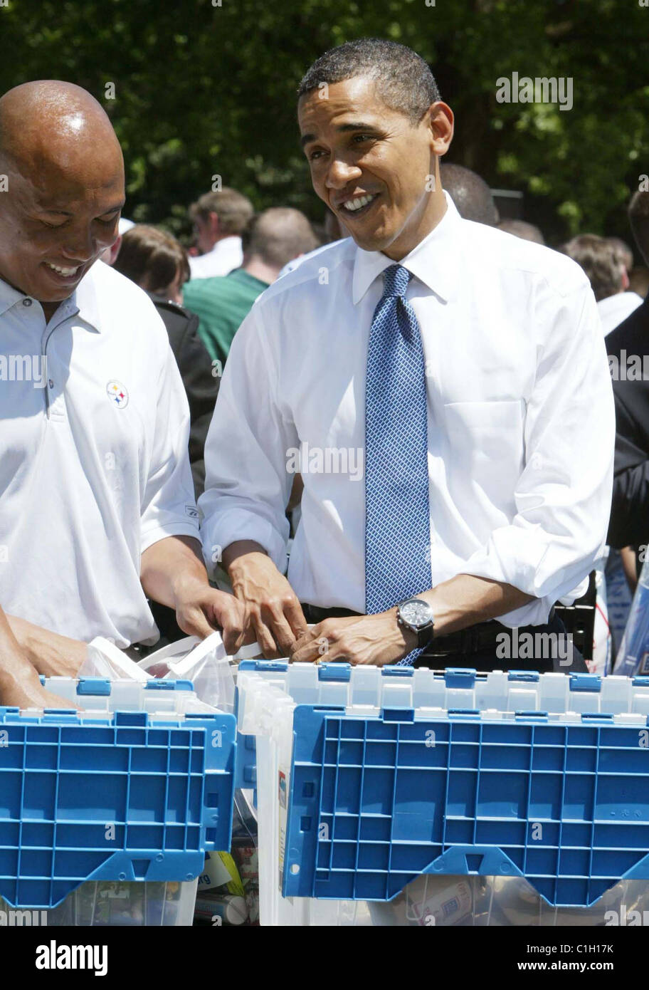 US President Barack Obama helps to assemble military care packages with ...