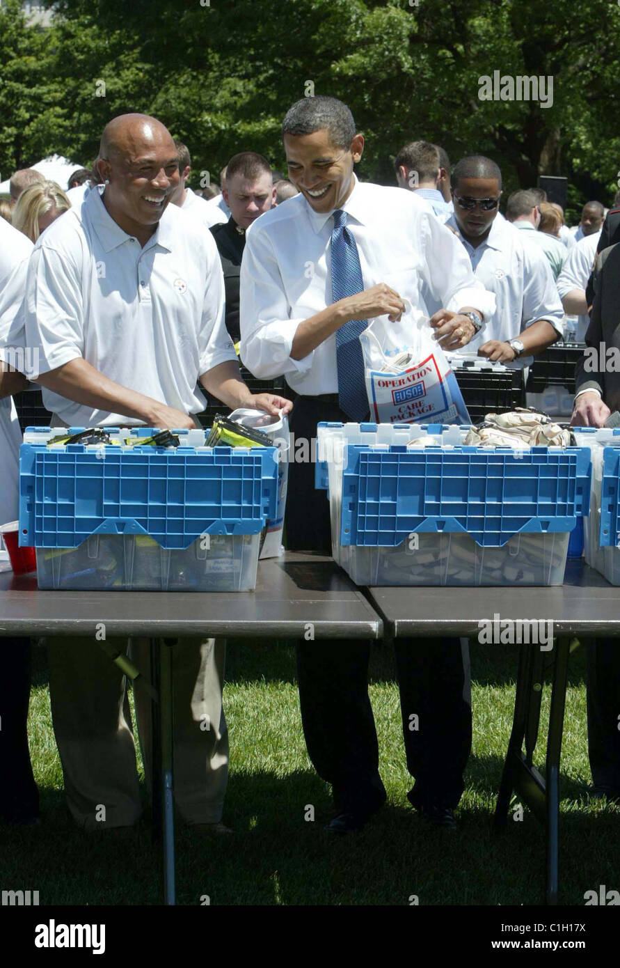 US President Barack Obama helps to assemble military care packages with ...