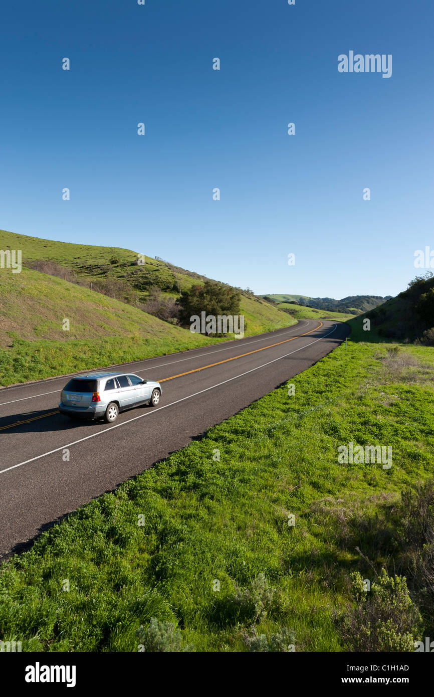 Car vehicle SUV automobile on highway winding through rolling hills ...