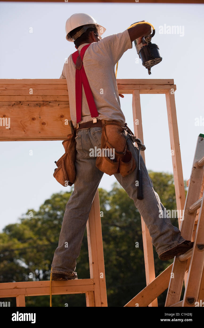 Carpenter nailing wall frame Stock Photo - Alamy