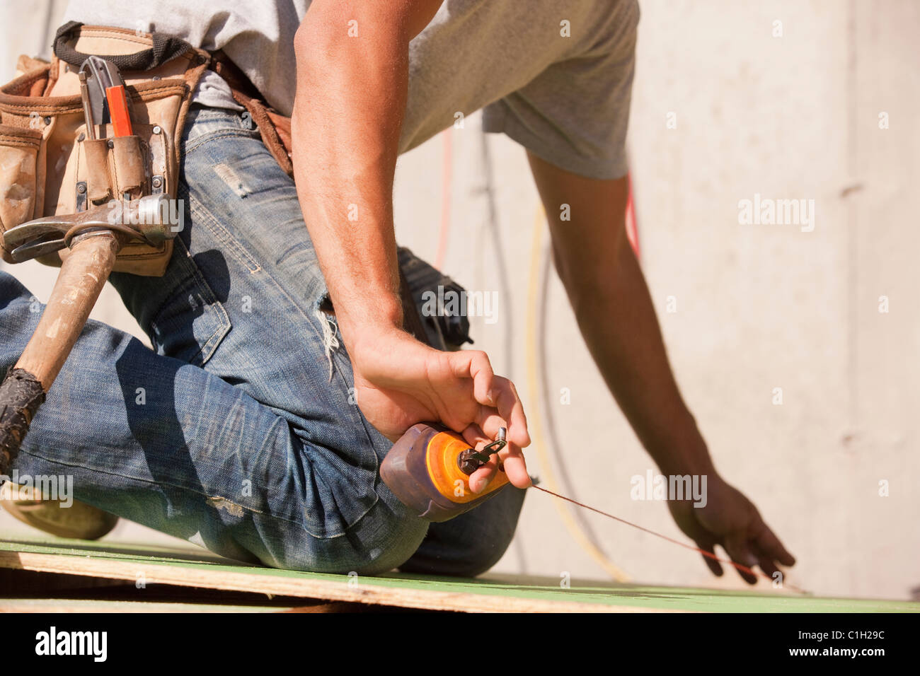 Carpenter using a snap line Stock Photo - Alamy