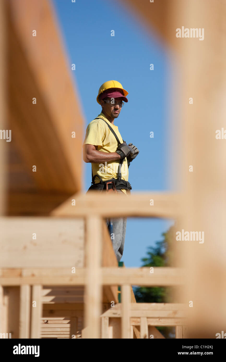 Carpenter standing on roof frame Stock Photo - Alamy