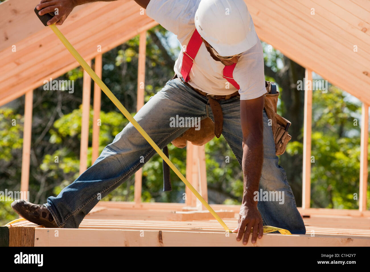 Carpenter measuring footers at construction site Stock Photo - Alamy