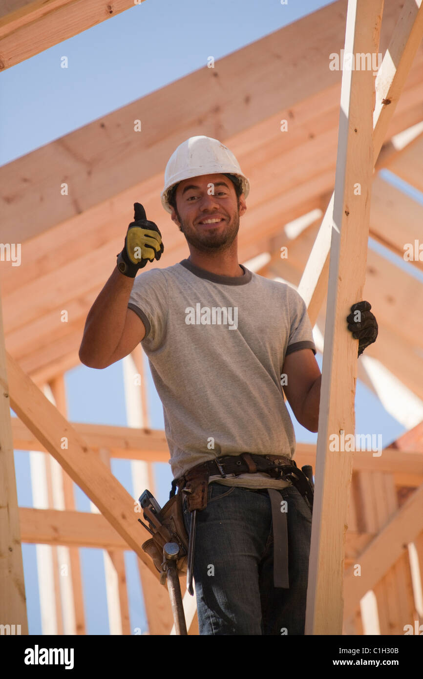 Carpenter showing thumbs up sign and smiling Stock Photo - Alamy