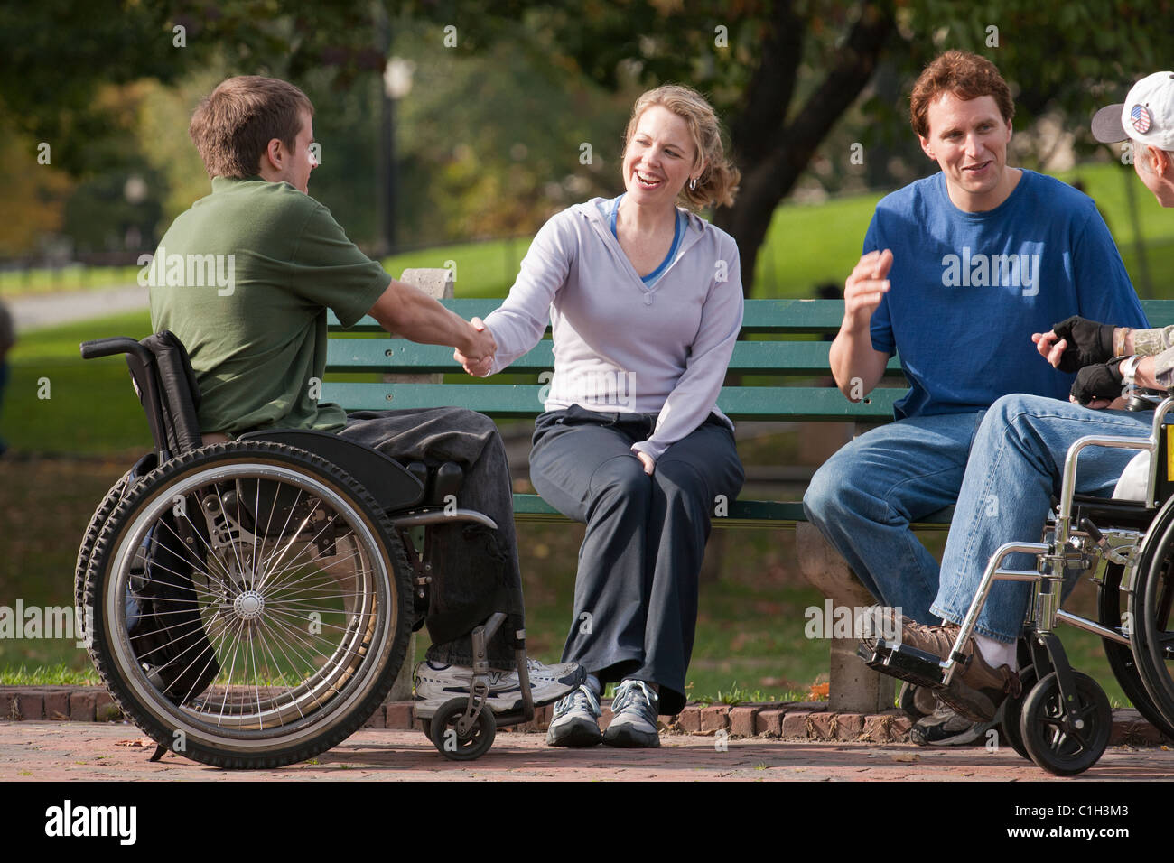 Veterans joining friends and shaking hands in the park Stock Photo - Alamy