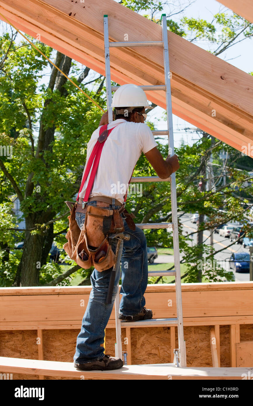 Carpenter climbing a ladder Stock Photo - Alamy