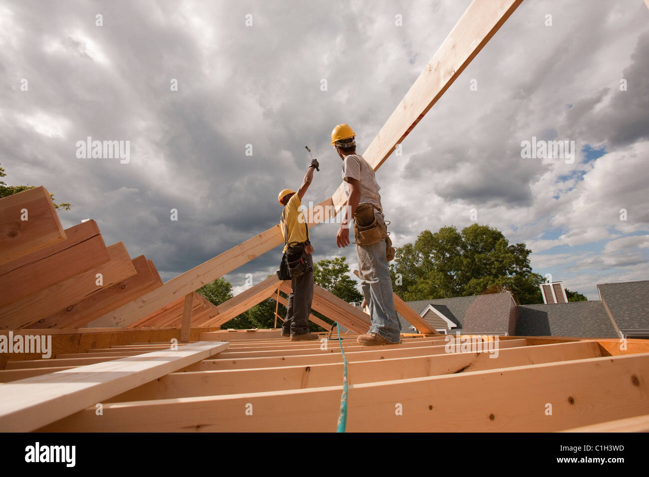 Carpenters hammering roof rafters to beam Stock Photo - Alamy