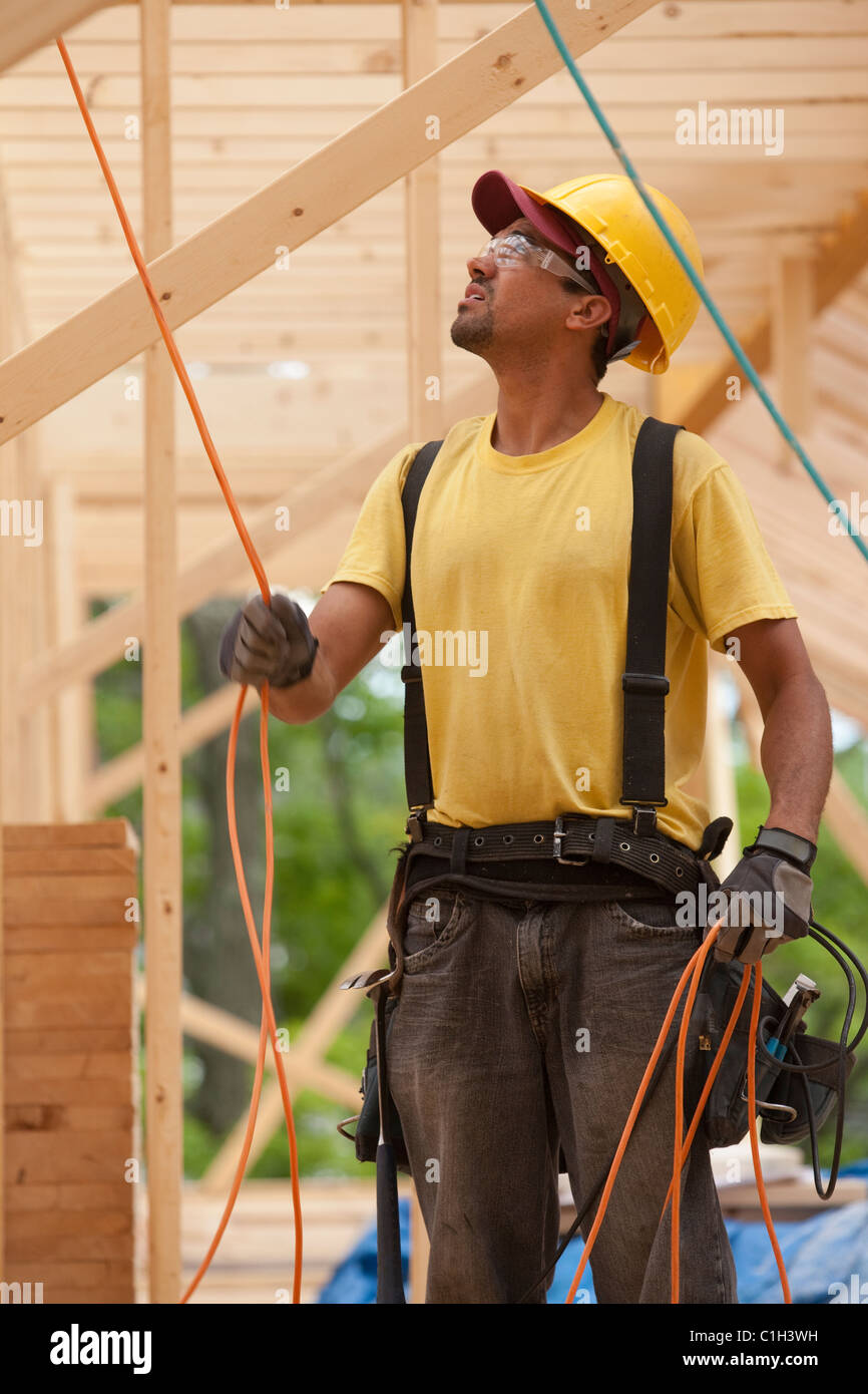 Carpenter arranging power cords Stock Photo - Alamy