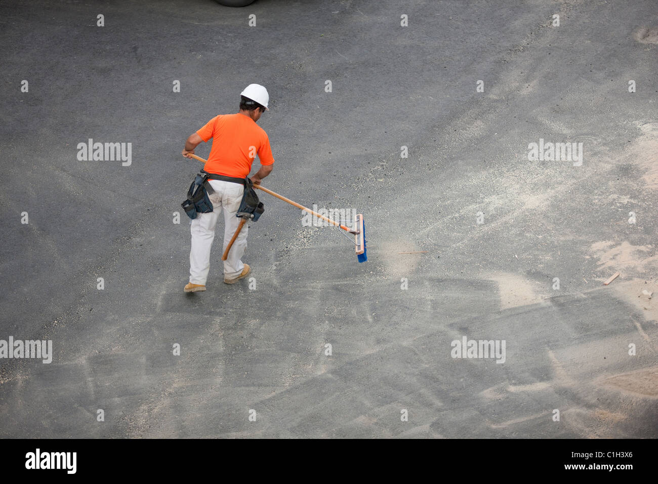 Carpenter sweeping up after building Stock Photo - Alamy
