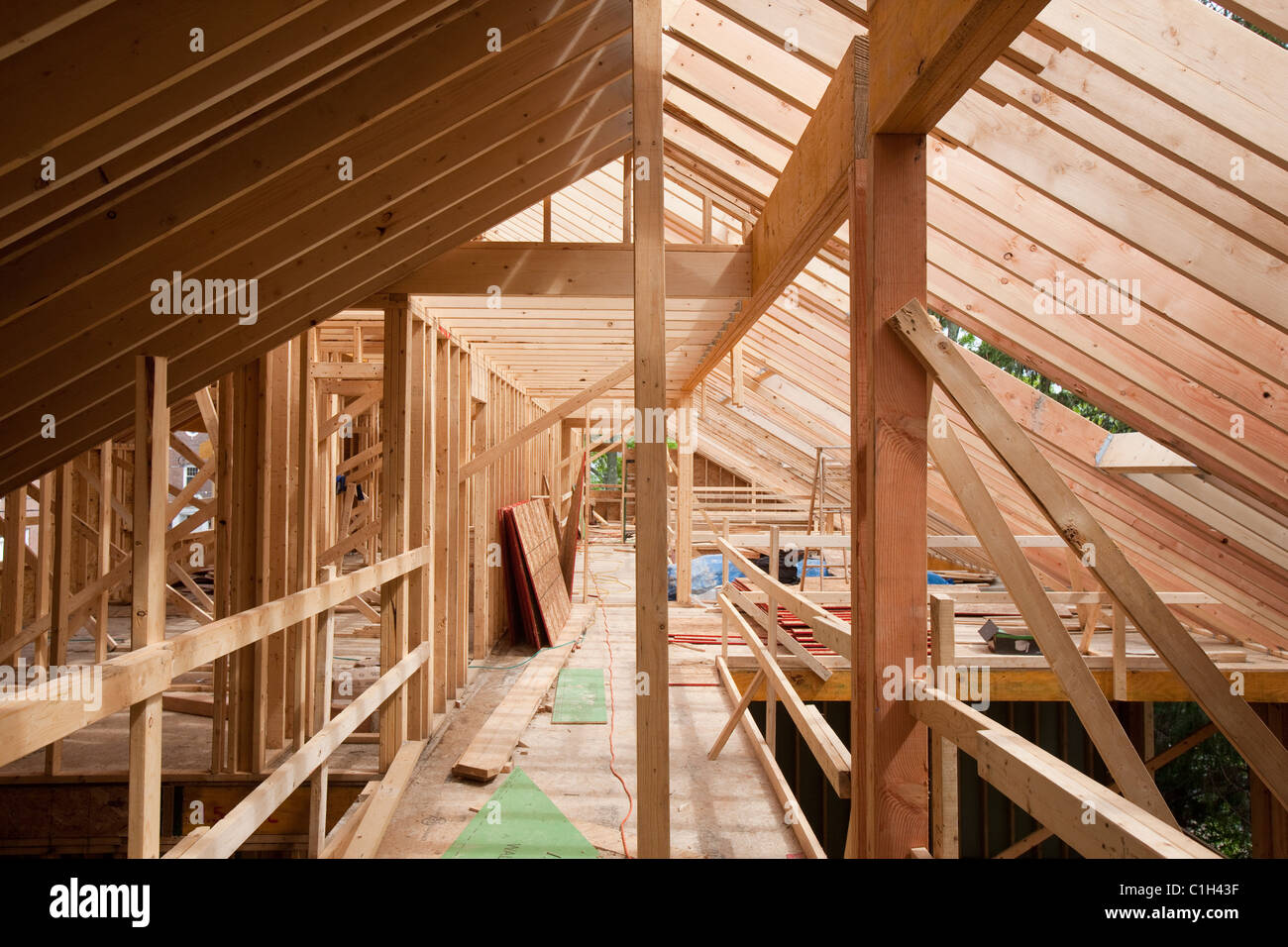 Upper floor room framing and rafters of a house under construction ...