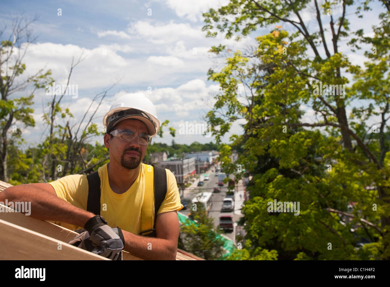 Hispanic carpenter resting on the roof construction of a house Stock ...
